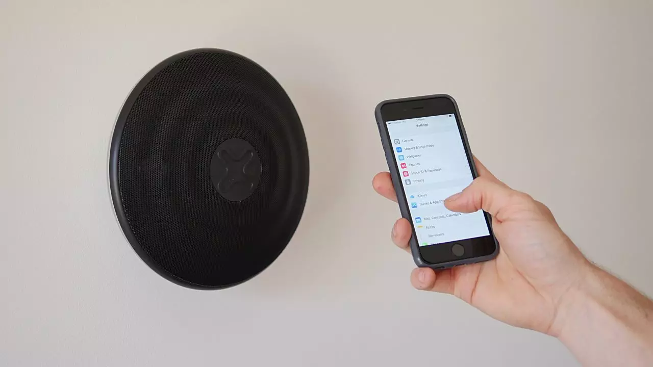 Studio Proper PA2 Bluetooth skaļrunis karājas pie sienas un pielīp pie jūsu iPhone