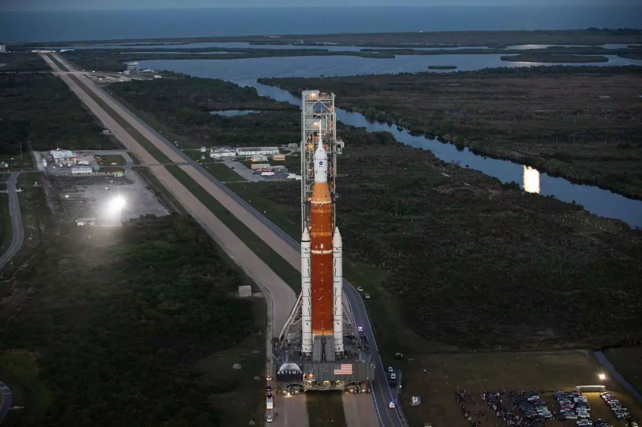 SLS - kalayan kapsul awak Orion di luhur - lalaunan jalan ka handap crawlerway di Kennedy Space Center.